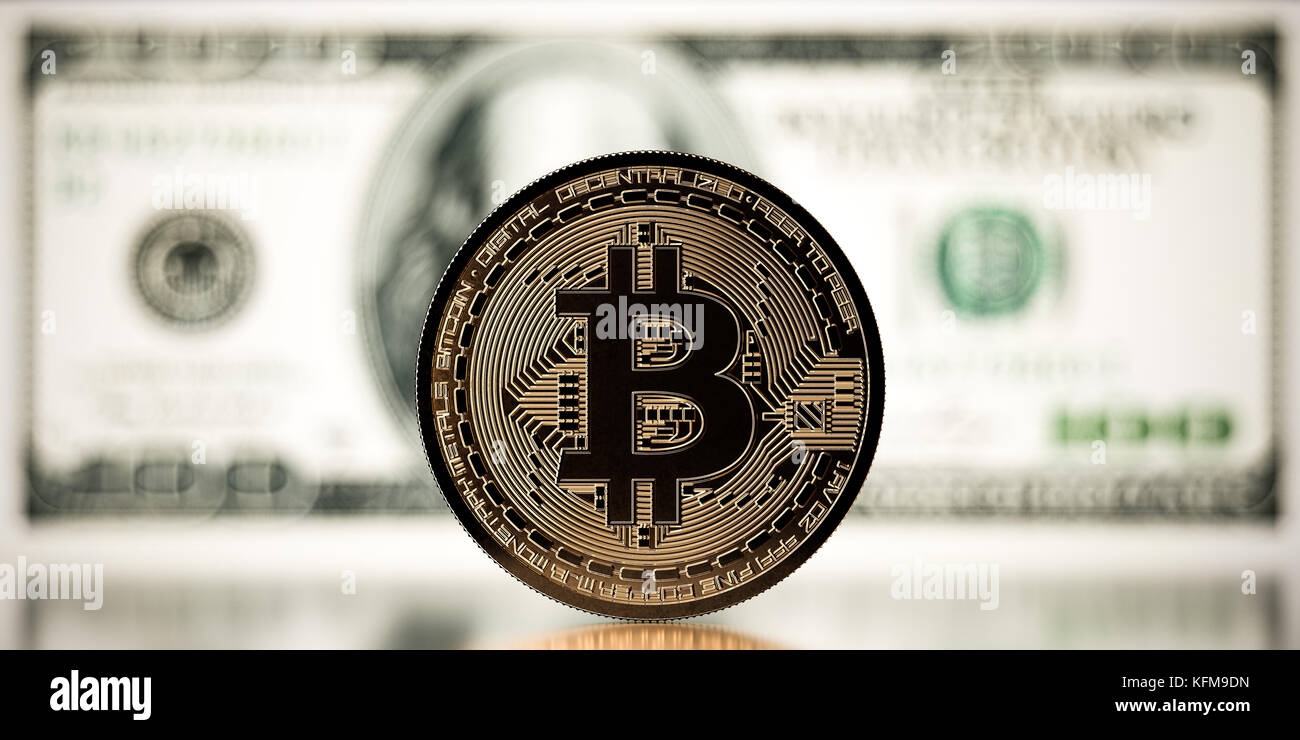 One Bitcoin golden coin on hundred dollars bills defocusing background. 3d rendering ...