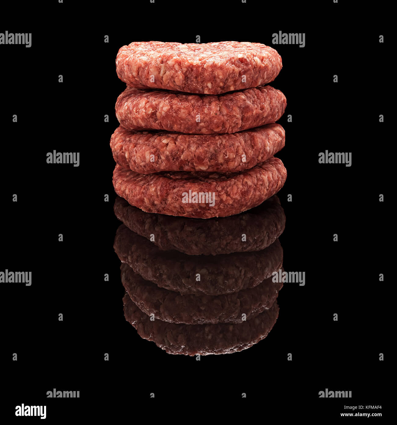 Stack of raw beef patties isolated on black glossy background with real ...