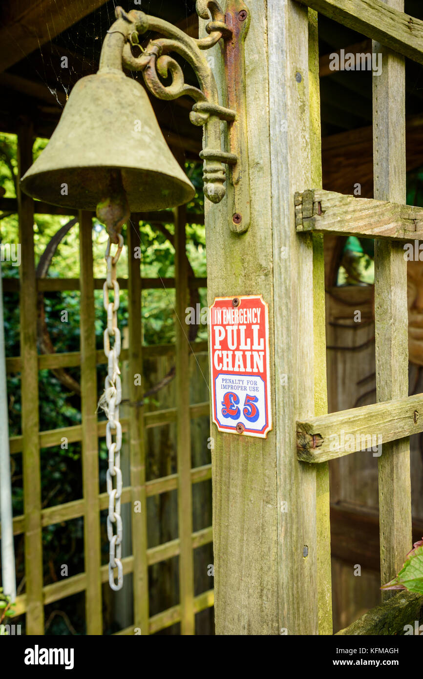 Rusty old bell with a sign reading. In emergency pull the chaiin Stock ...