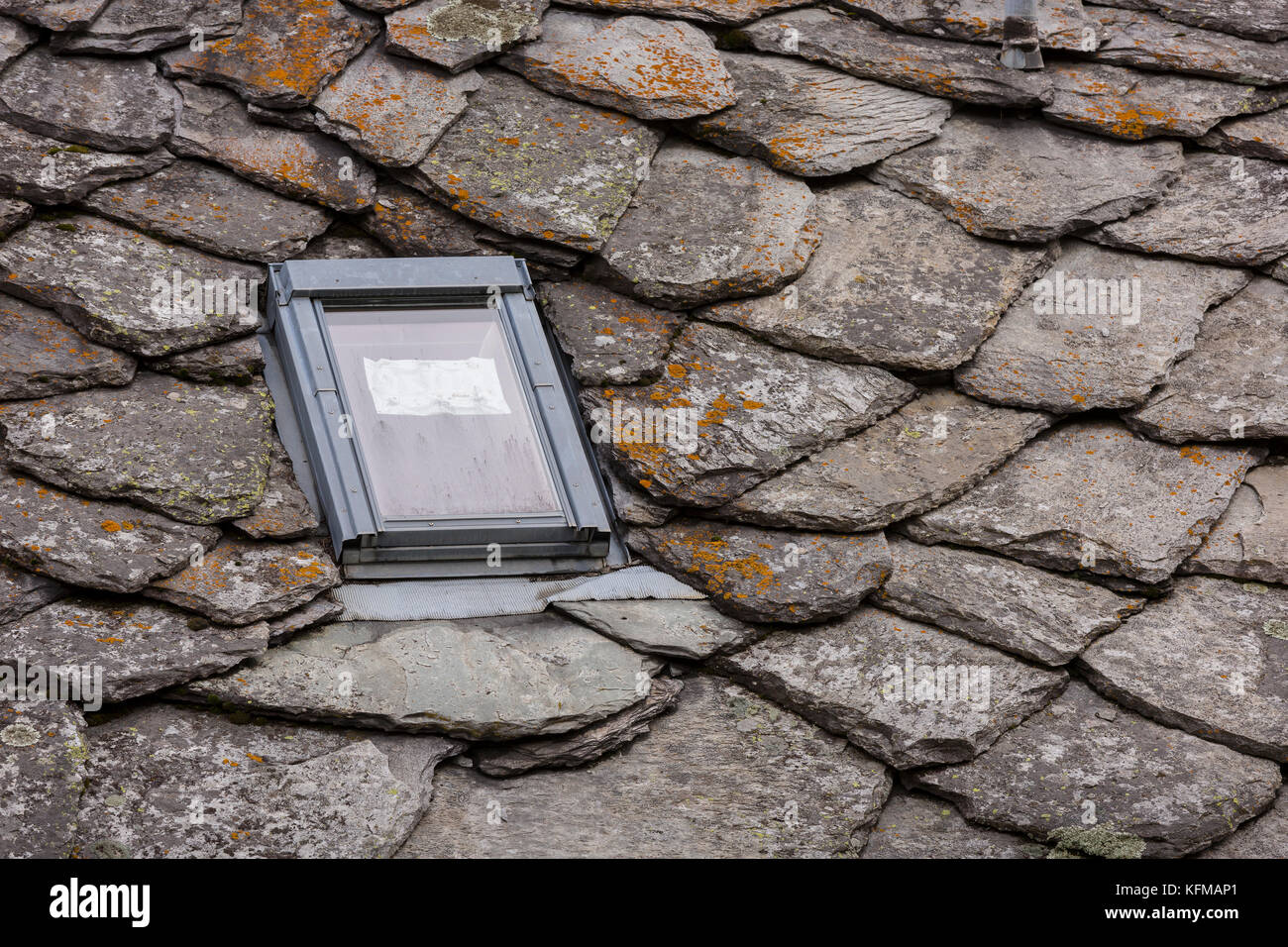 ST. NIKLAUS, SWITZERLAND - Modern skylight in traditional slate roof on ...