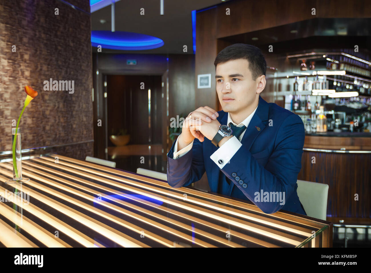 Groom sitting at the table in a bar and waiting for his bride Stock ...