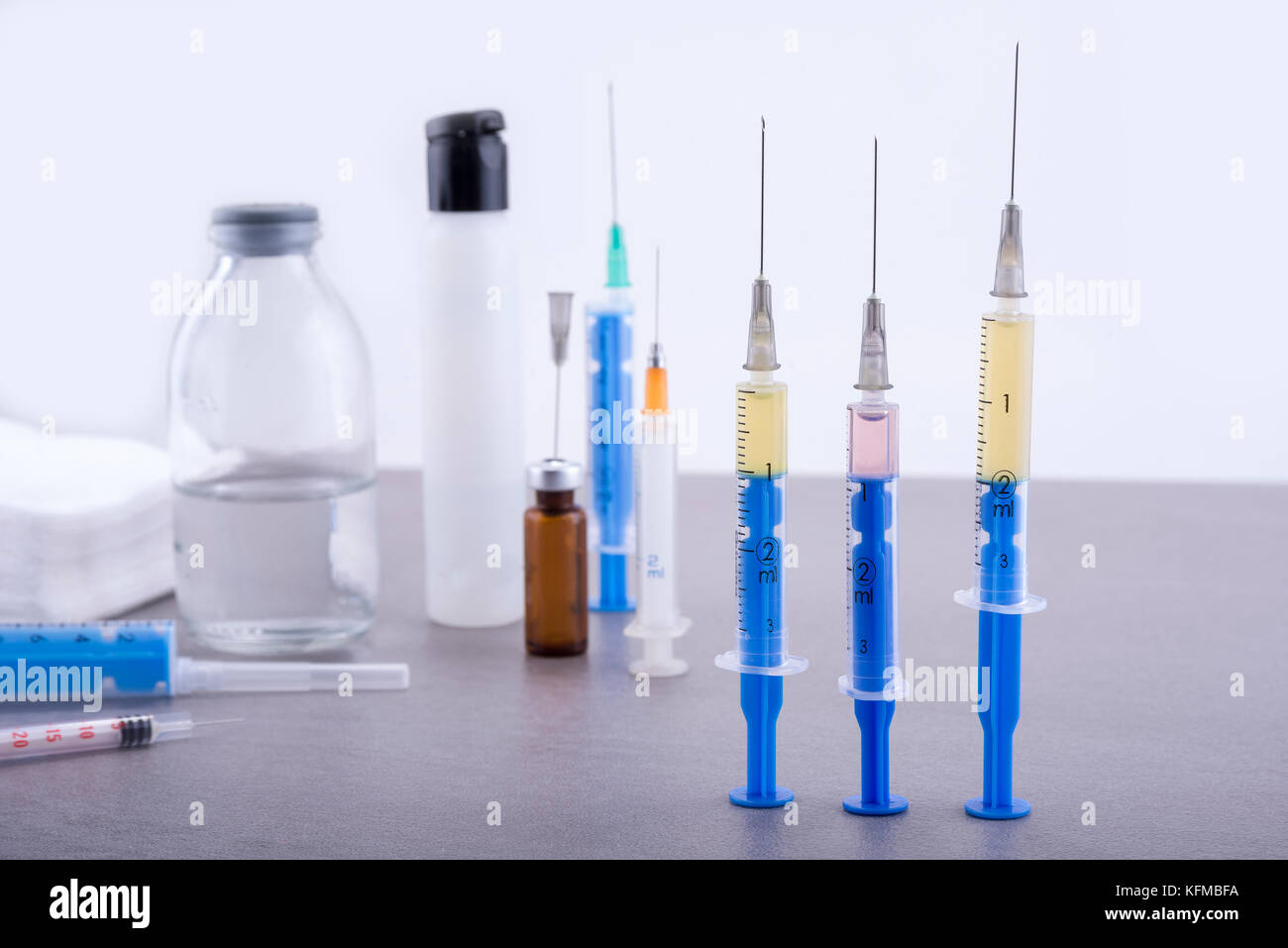 Doctor table with shots and disinfectant ready to use Stock Photo - Alamy