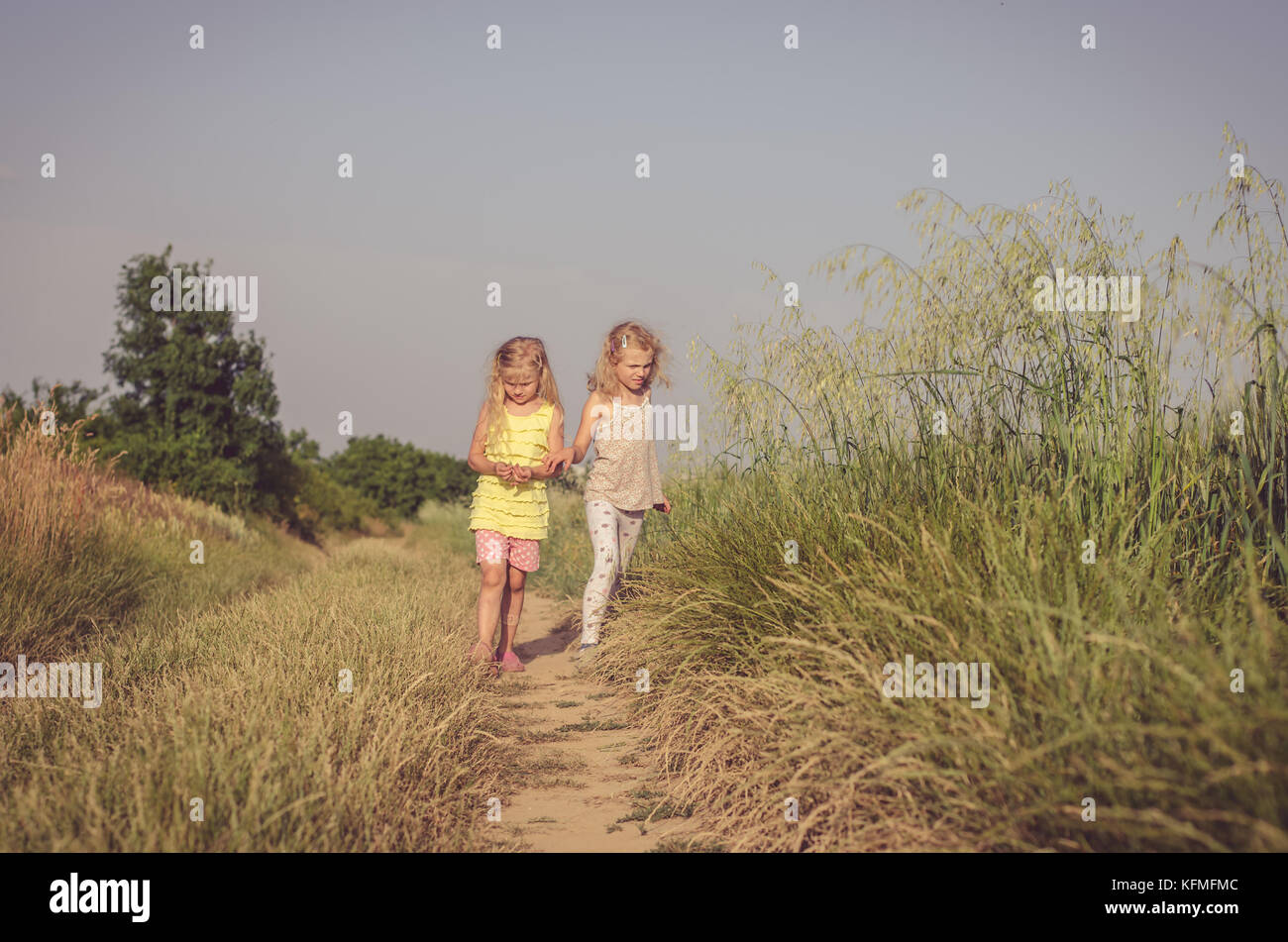 two kids walking together in the rural country path Stock Photo - Alamy