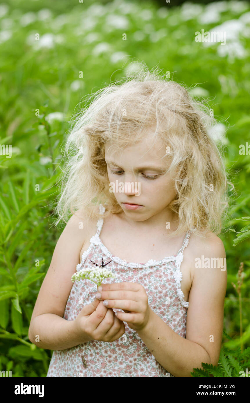little blond girl with floral background Stock Photo - Alamy