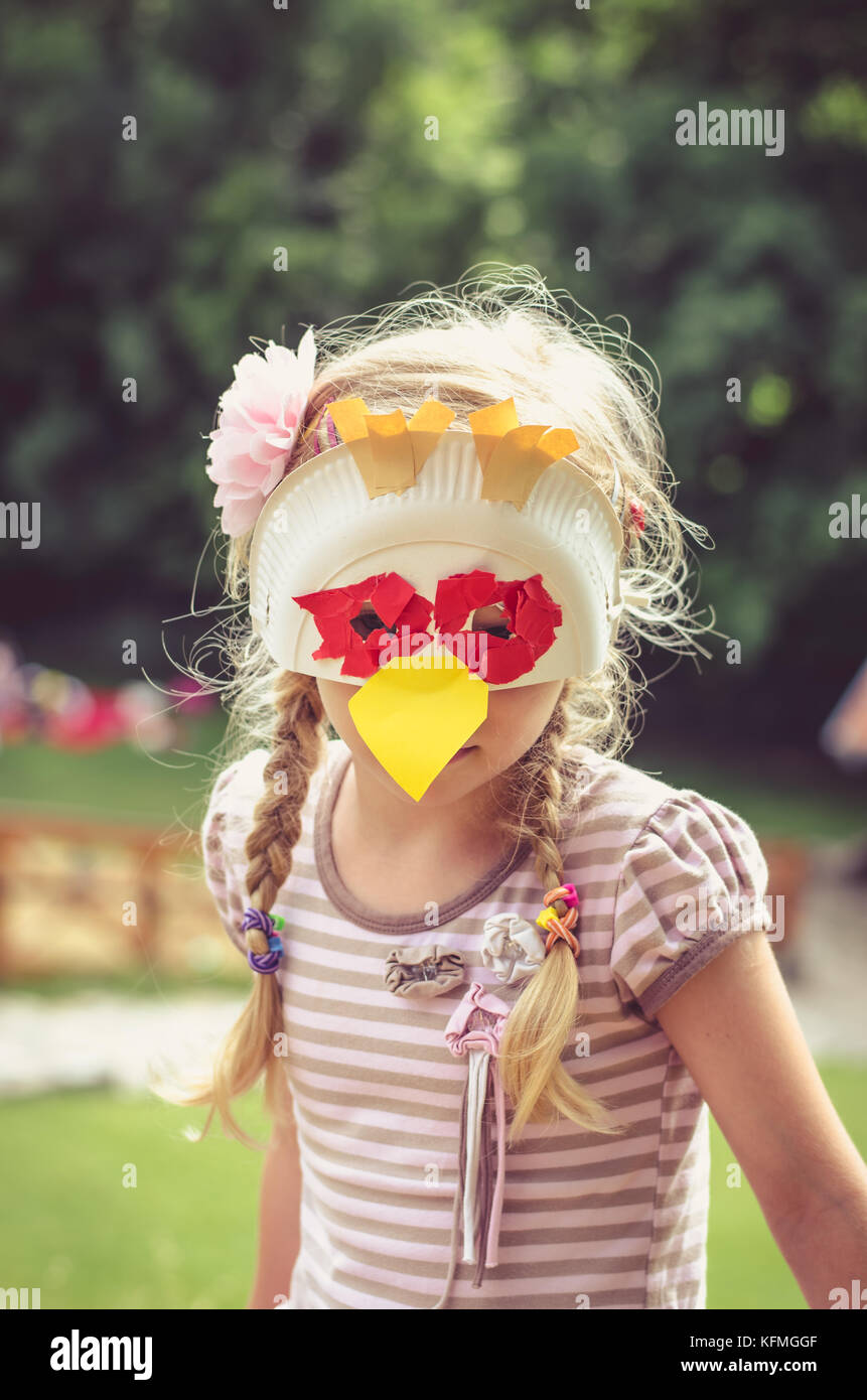 portrait of lovely blond caucasian girl with chicken mask from paper ...