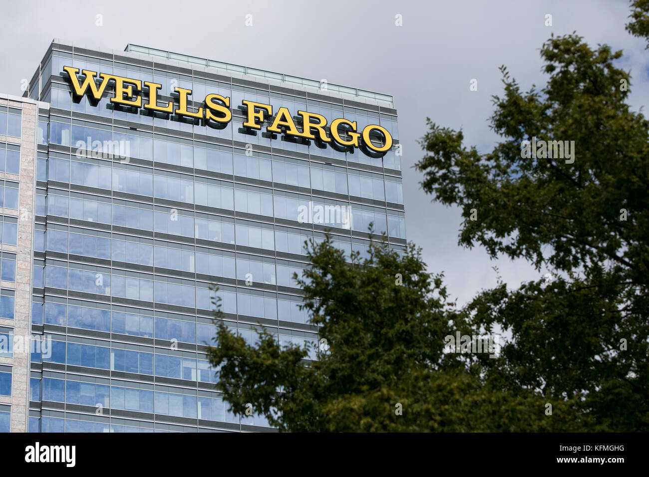 A logo sign outside of a facility occupied by Wells Fargo & Company in ...