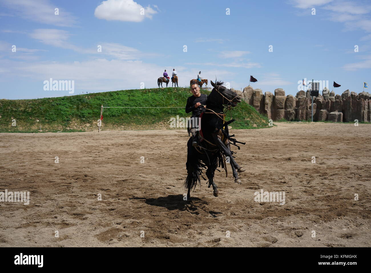 "Up!Up!" a Mongolian rider said to his black steed while he was pulling ...