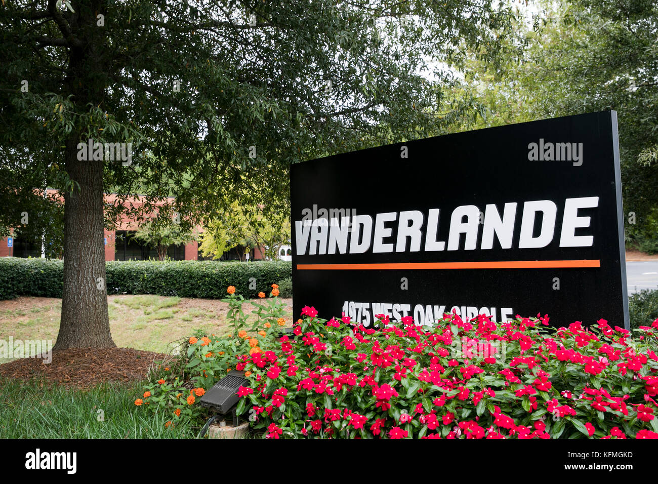 A logo sign outside of a facility occupied by Vanderlande Industries in ...