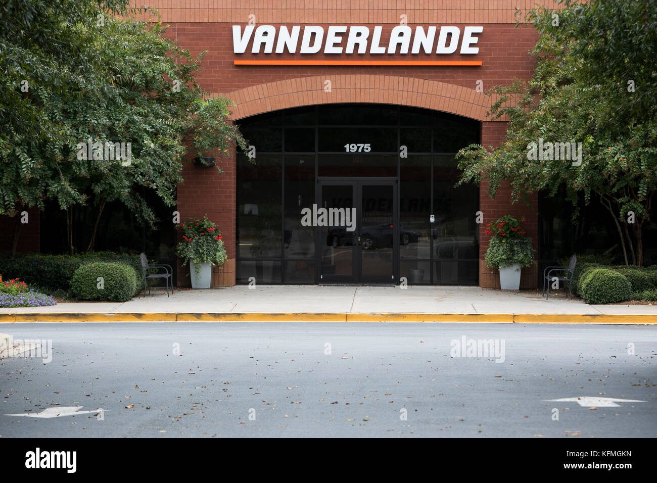 A logo sign outside of a facility occupied by Vanderlande Industries in ...