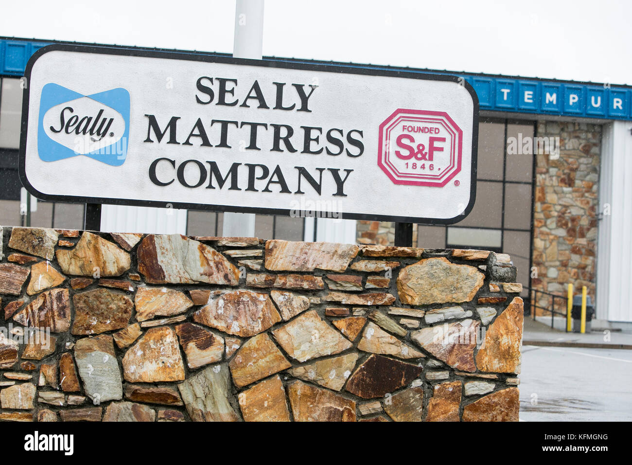 A logo sign outside of a facility occupied by the Sealy Mattress ...