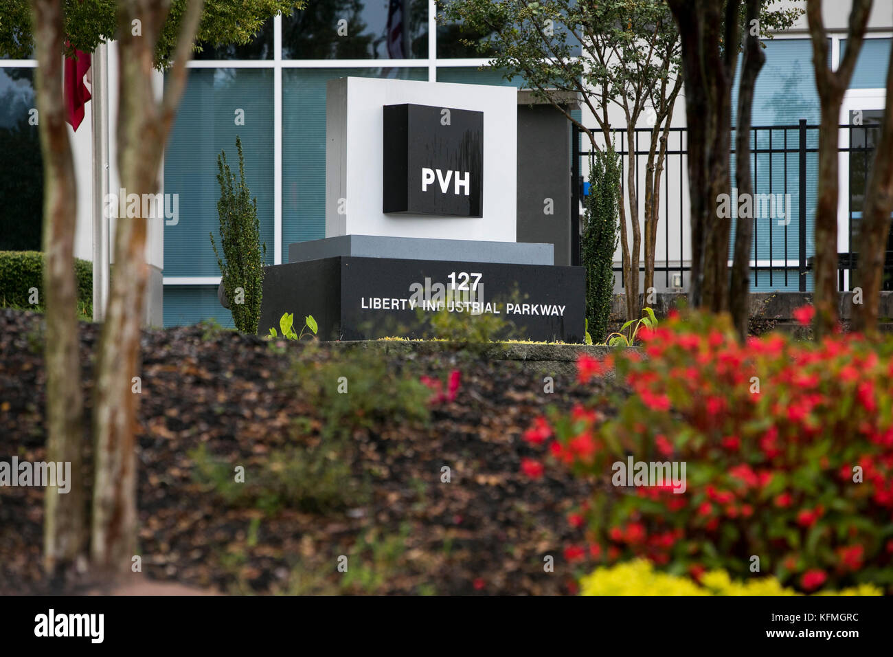 A logo sign outside of a facility occupied by the PVH Corporation ...