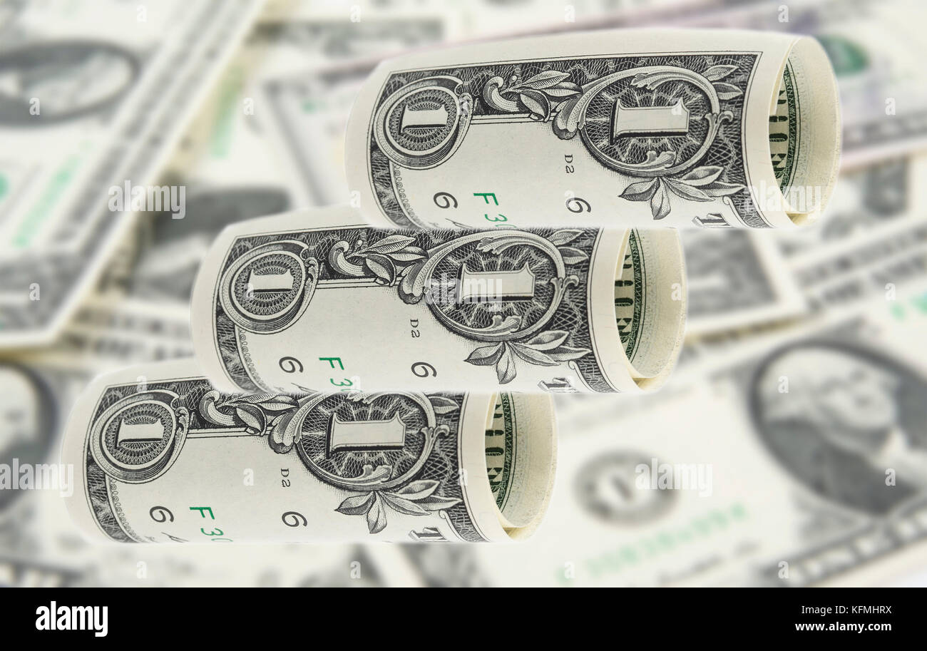 Three one dollar banknote in the rolls on the white background Stock ...