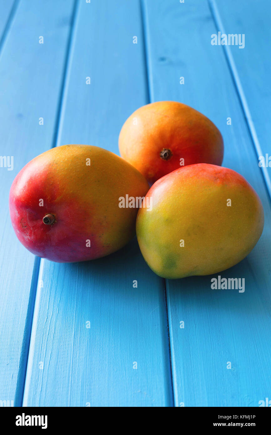 Mango fruits of the blue wooden background Stock Photo - Alamy