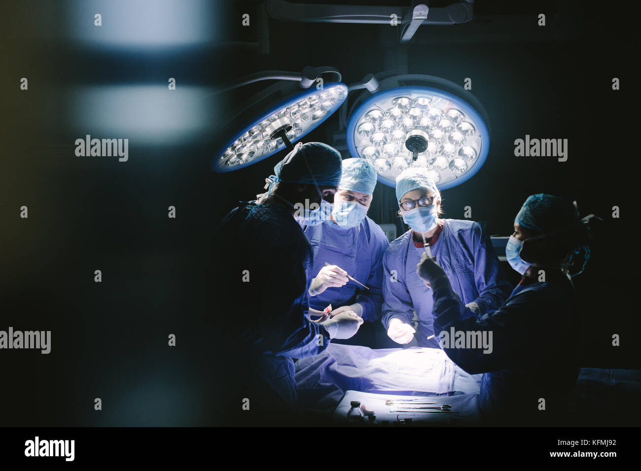 Group of surgeons in operating theater. Medical team performing surgery ...