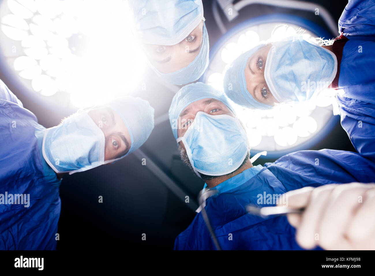 POV shot of surgeons under surgery lights in operating theatre ...