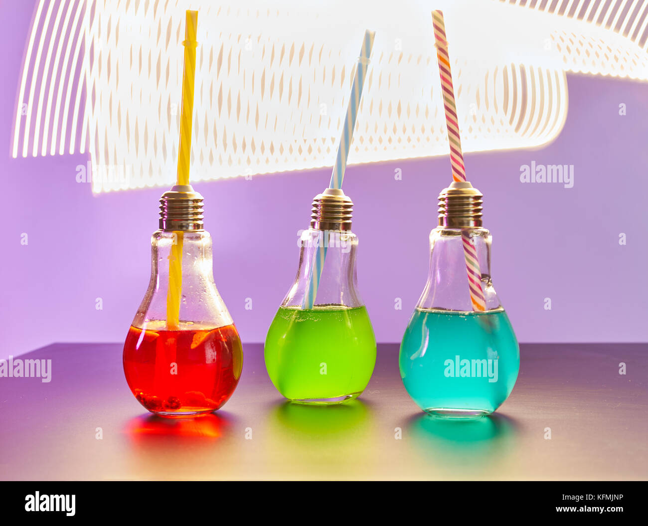 Three colorful cocktails for party in light bulb shaped glasses Stock ...