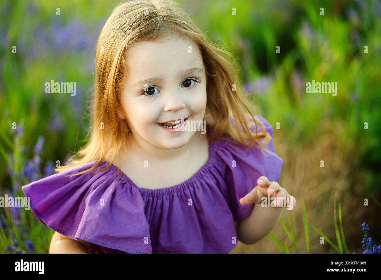 Cute little girl on the meadow in spring day Stock Photo - Alamy