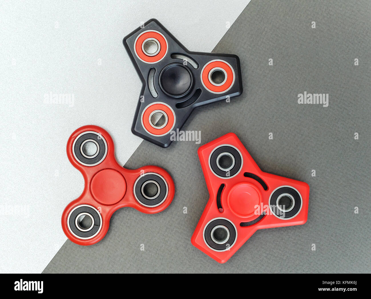Three spinners on a gray background Stock Photo - Alamy
