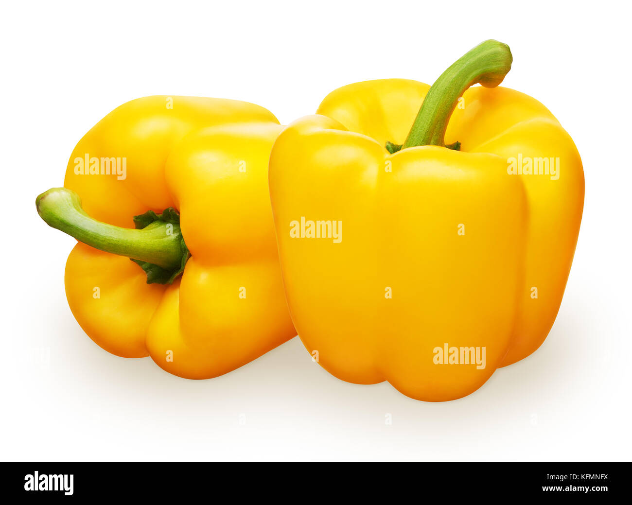 Whole fresh yellow bell pepper next to pepper lying on its side ...