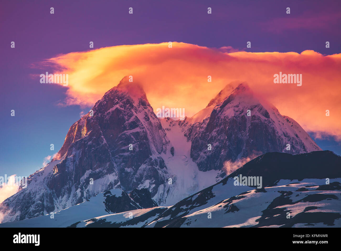 Sunset evening view over the snowy mountain range Stock Photo - Alamy