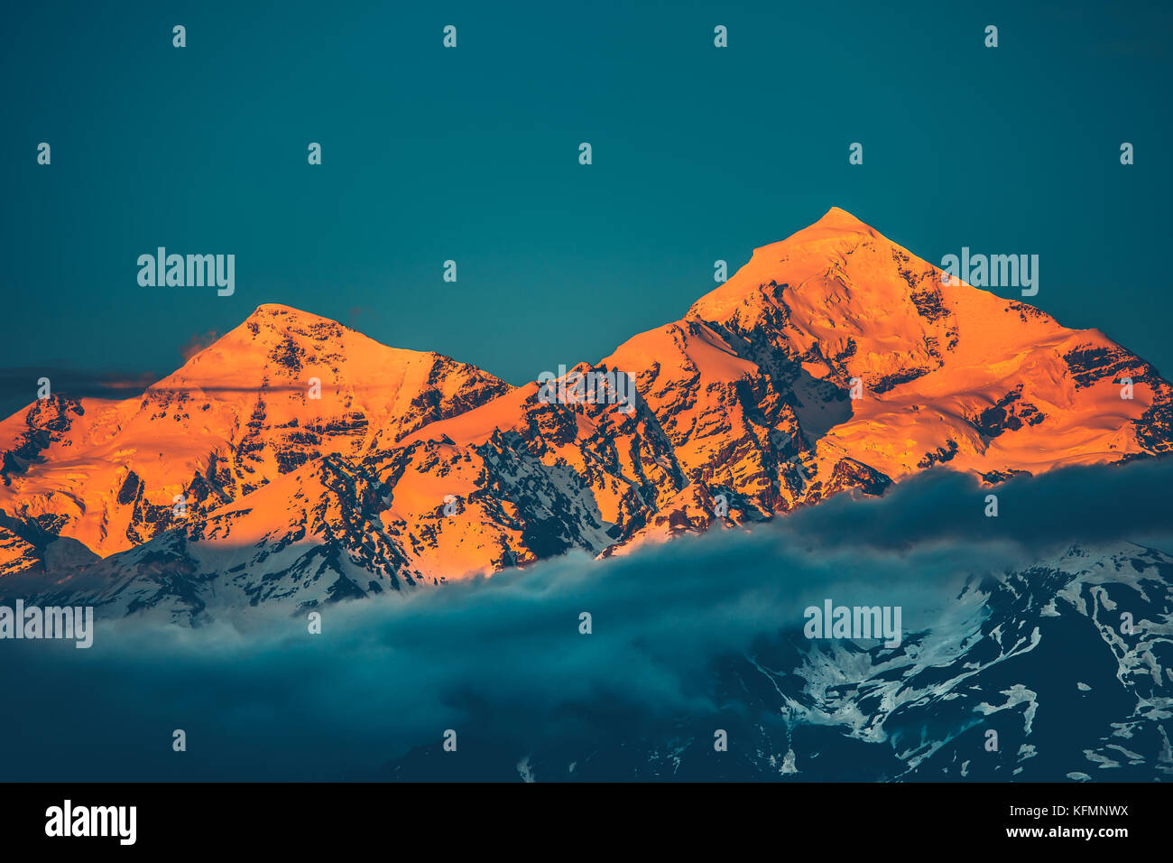 Sunset evening view over the snowy mountain peak Stock Photo - Alamy