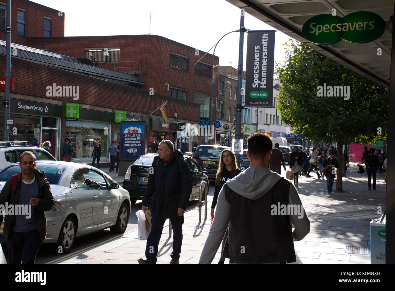 People walking on High Street in sunny day.King Street,Hammersmith ...