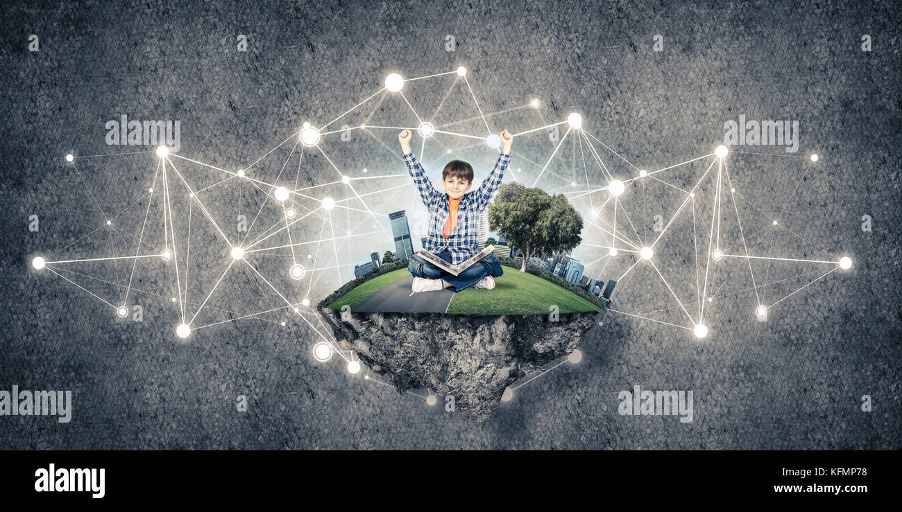 Cute boy of school age with book exploring this great world Stock Photo ...