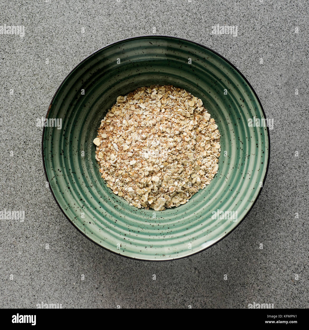Bowl with oatmill on grey background Stock Photo - Alamy