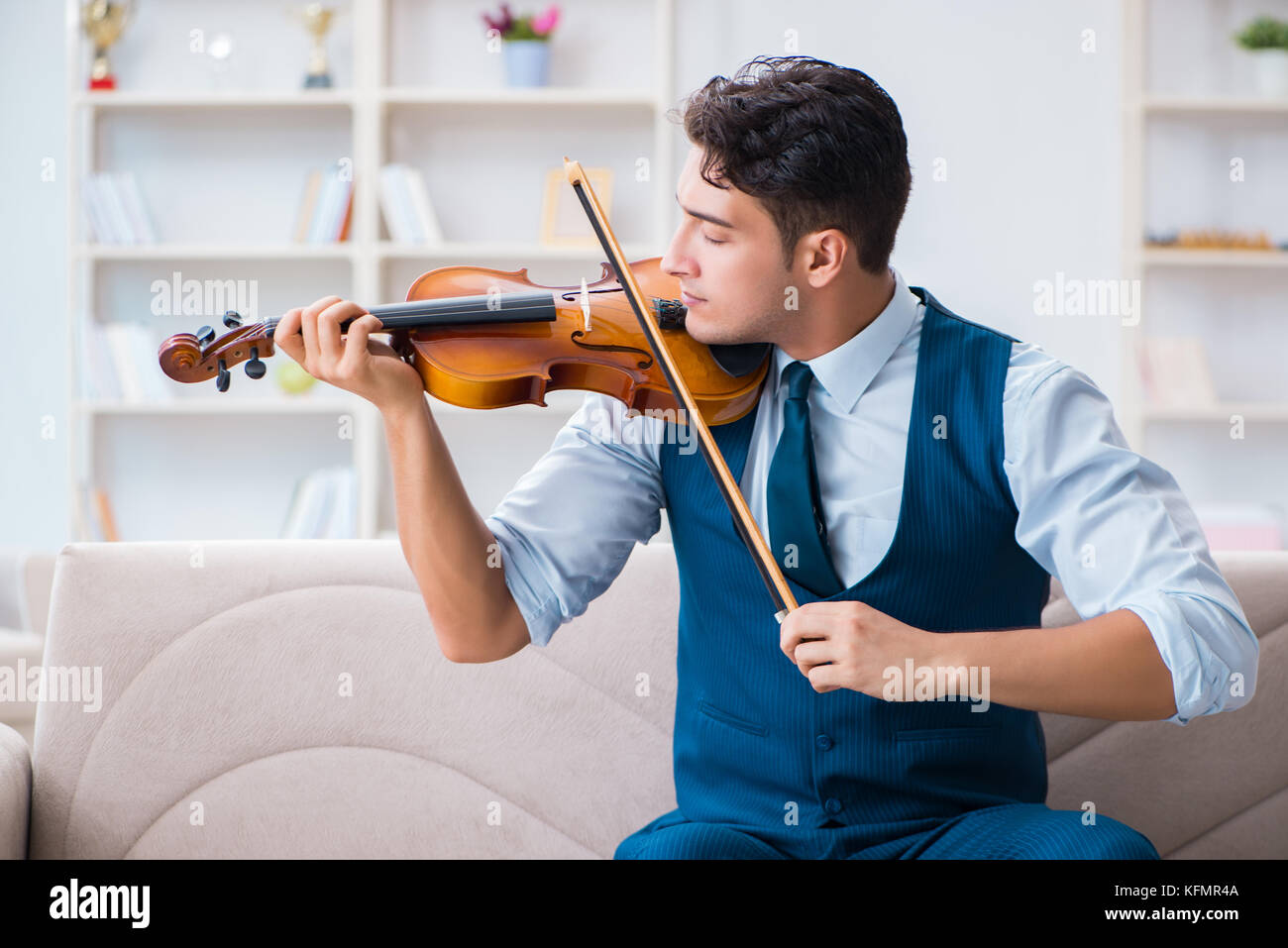 Young musician man practicing playing violin at home Stock Photo - Alamy