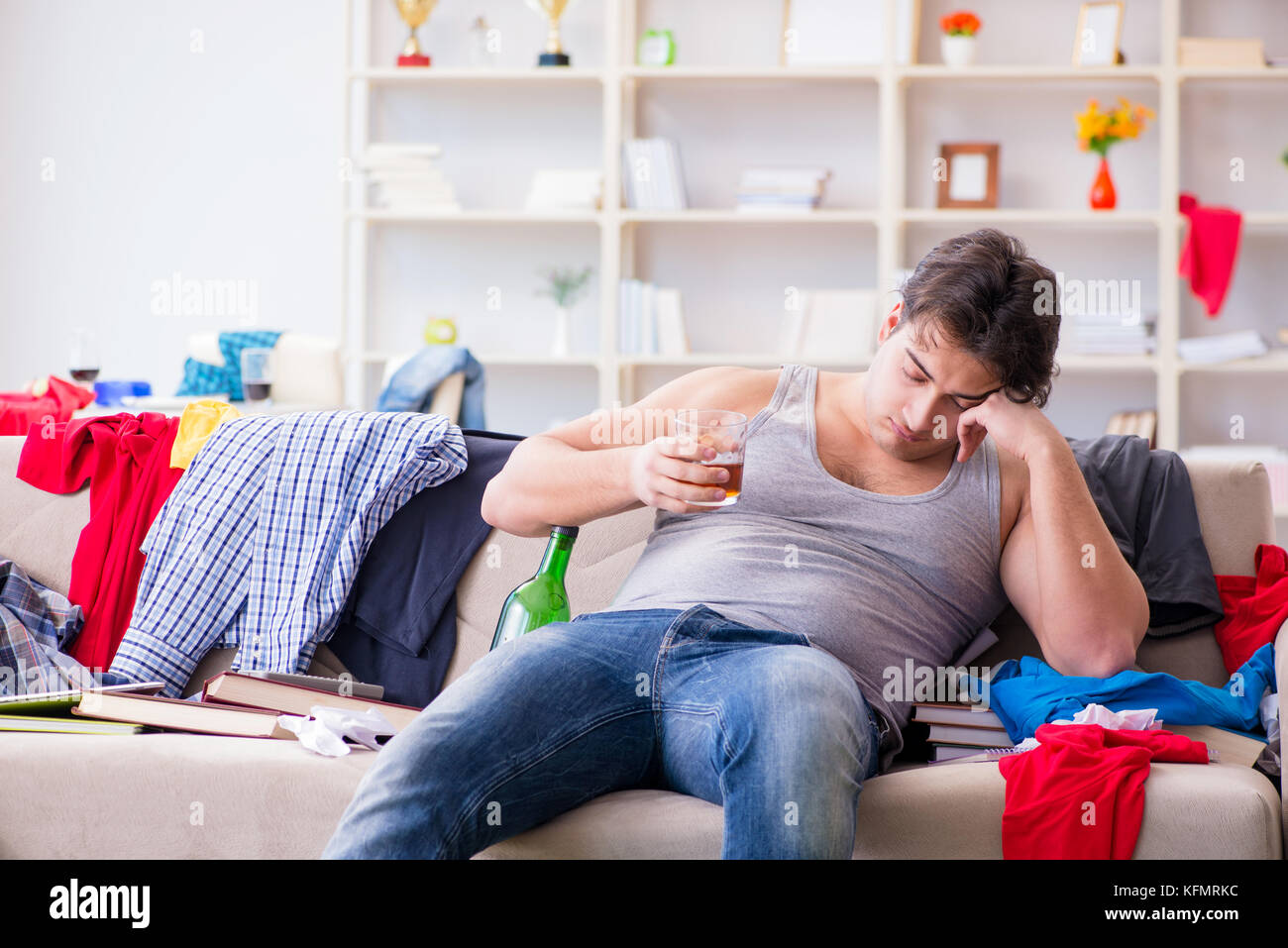 Young man student drunk drinking alcohol in a messy room Stock Photo ...