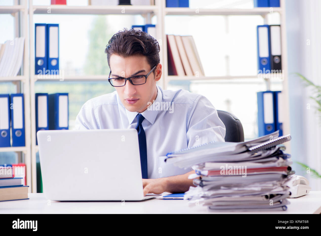 Businessman with excessive work paperwork working in office Stock Photo ...