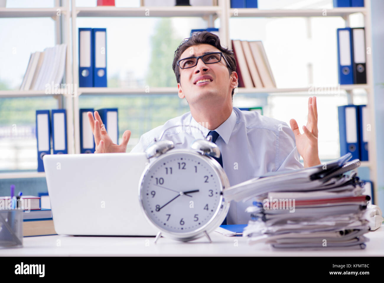 Businessman missing deadline for deliverables in office Stock Photo - Alamy