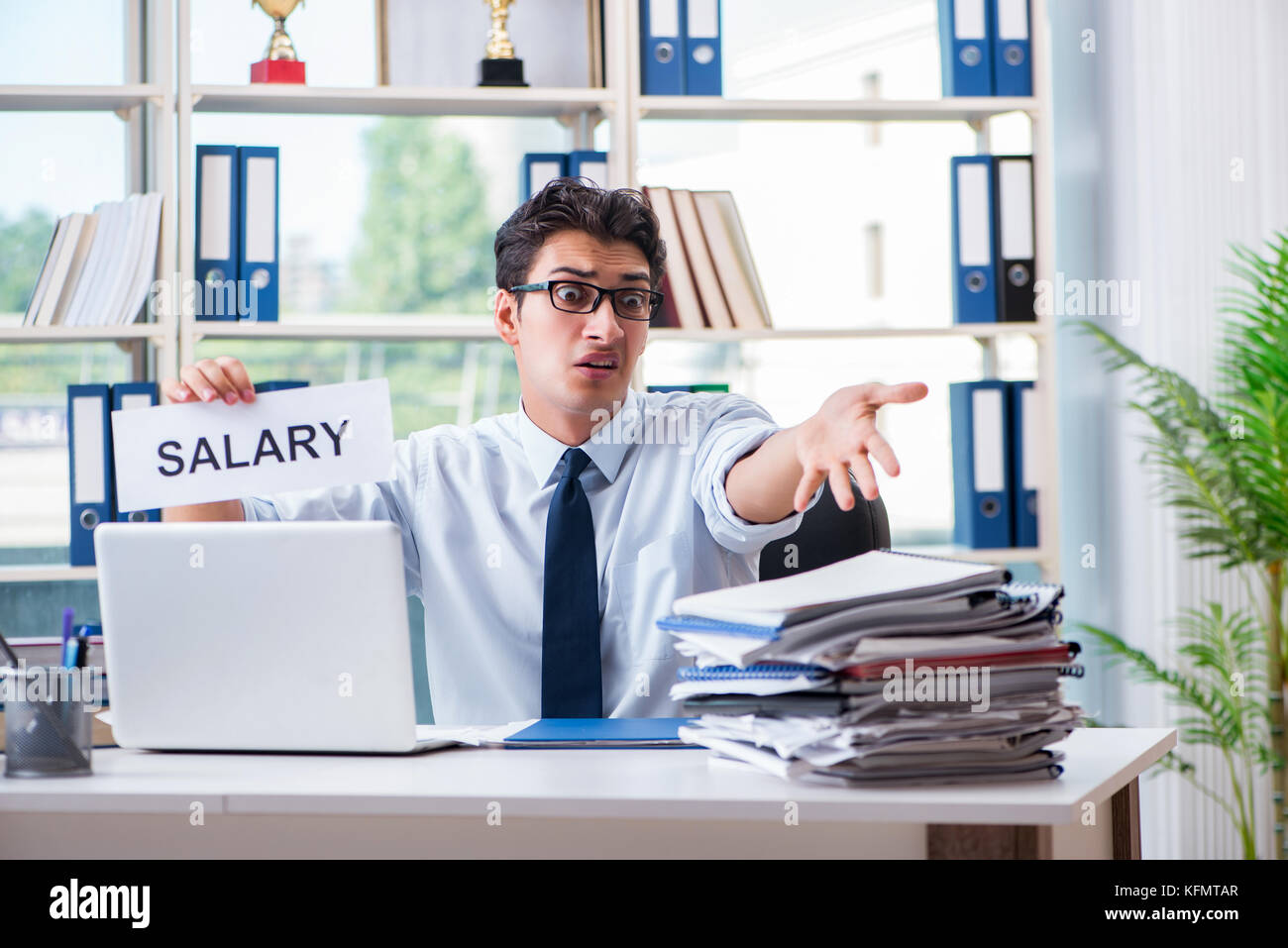 Young businessman asking for salary increase in office Stock Photo - Alamy