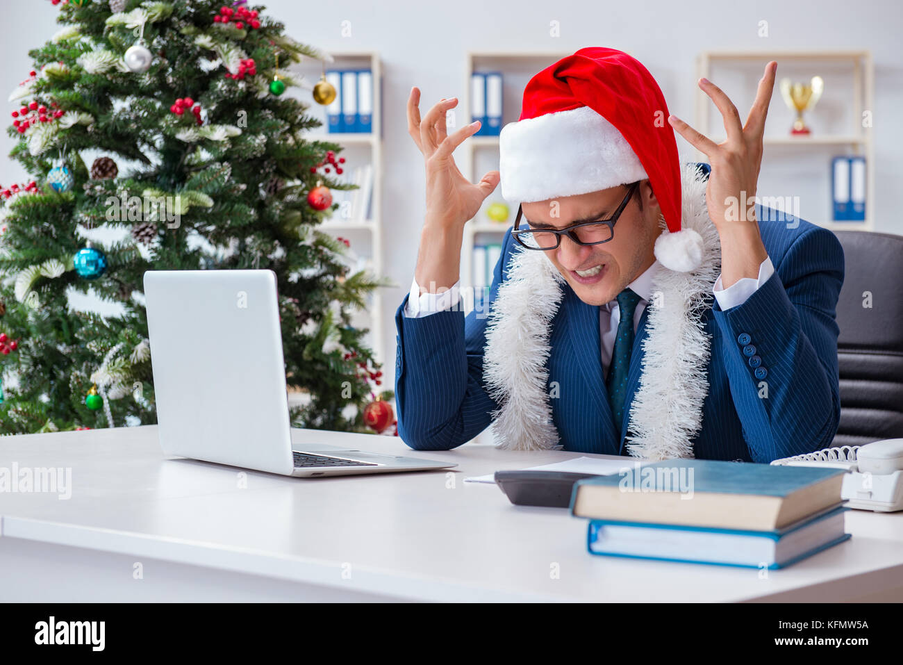 Businessman celebrating christmas holiday in the office Stock Photo - Alamy