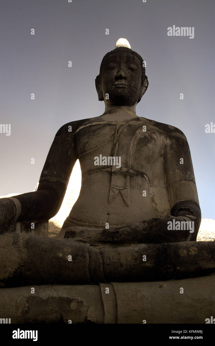 Buddha statue in shadow Stock Photo - Alamy