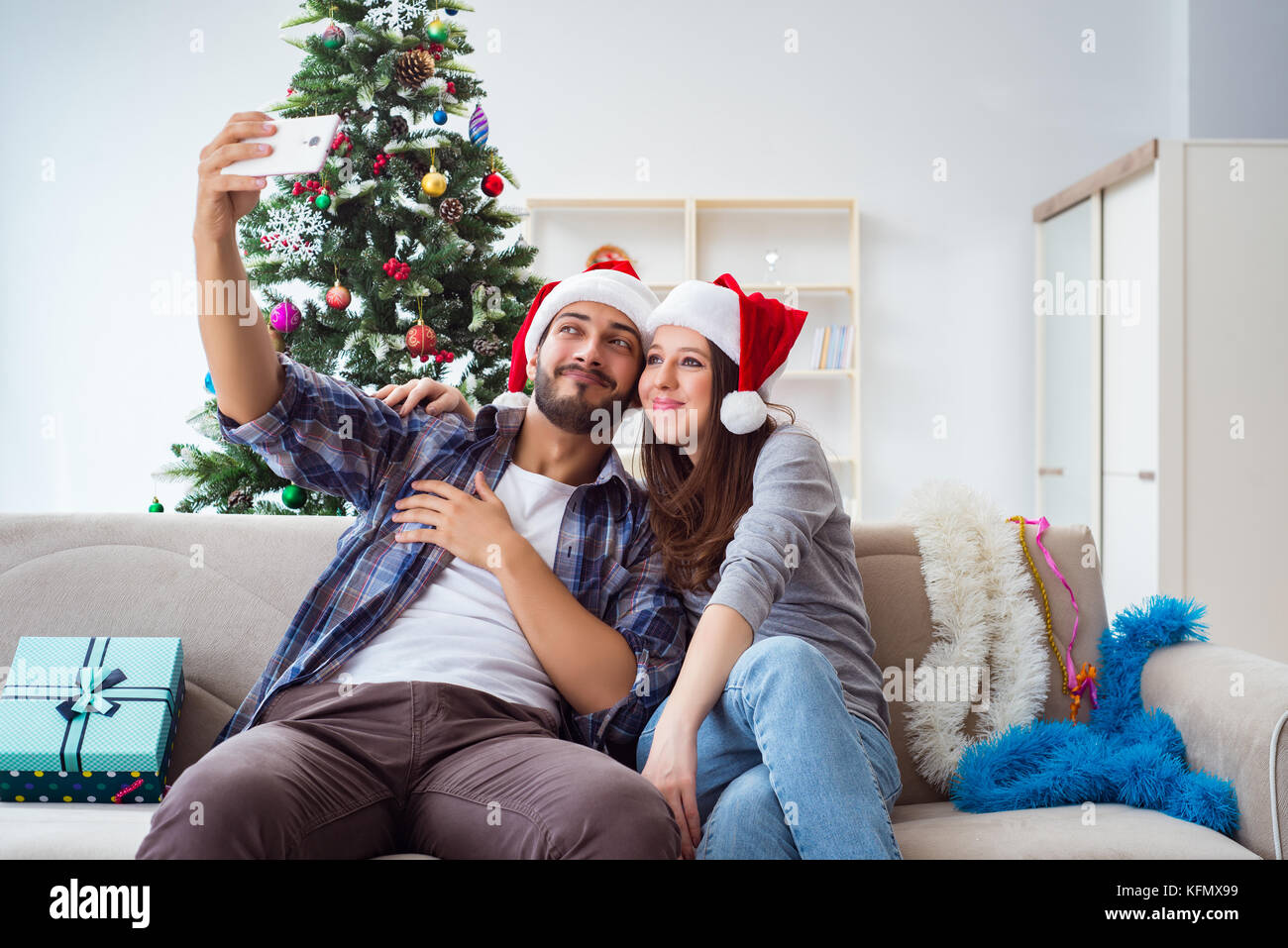 Young pair taking selfies during christmas Stock Photo - Alamy