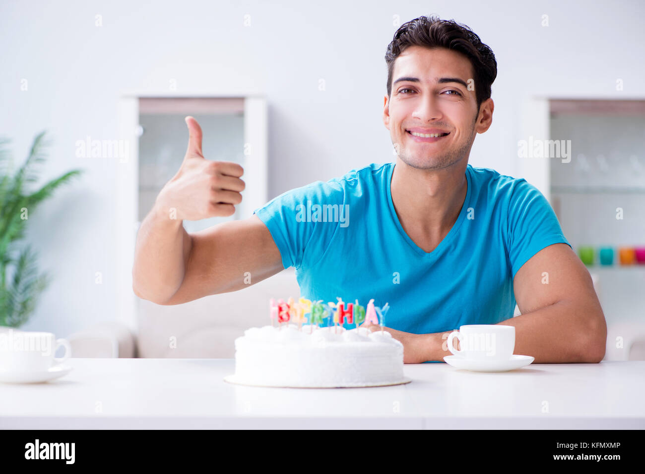 Young man celebrating birthday alone at home Stock Photo - Alamy
