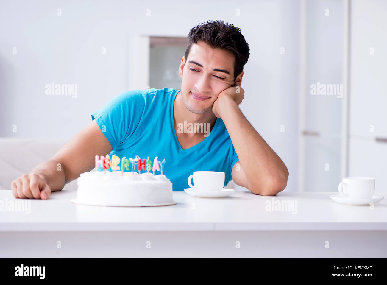 Young man celebrating birthday alone at home Stock Photo - Alamy