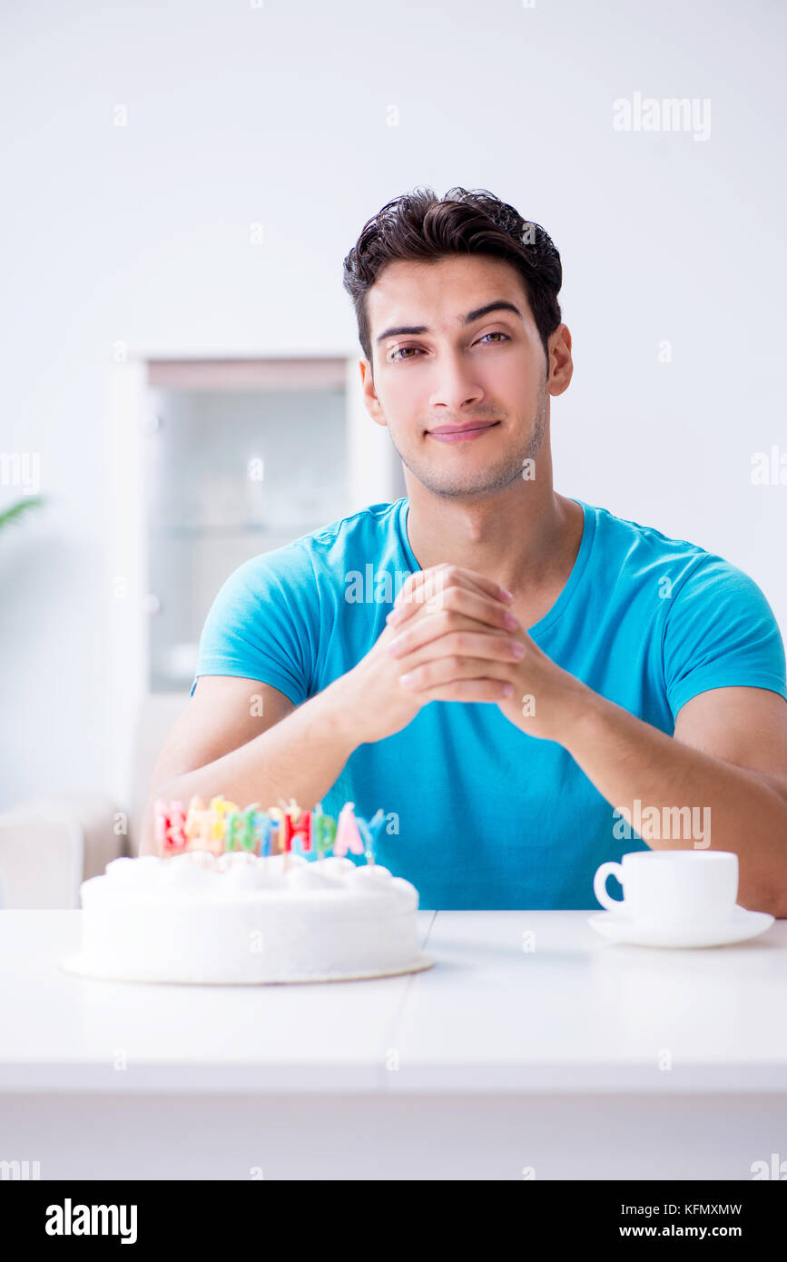 Young man celebrating birthday alone at home Stock Photo - Alamy