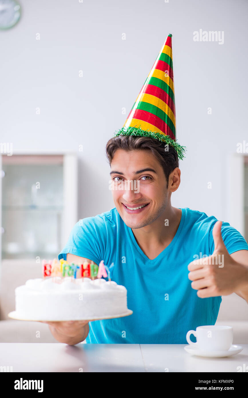 Young man celebrating birthday alone at home Stock Photo - Alamy