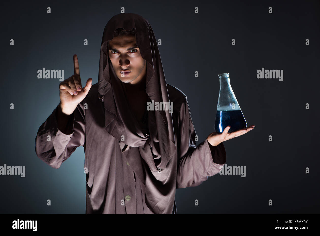 Alchemist doing experiments in alchemy concept Stock Photo - Alamy