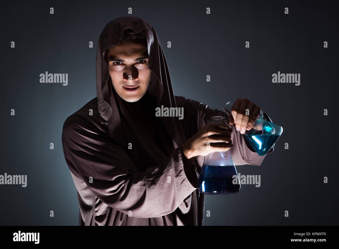 Alchemist doing experiments in alchemy concept Stock Photo - Alamy