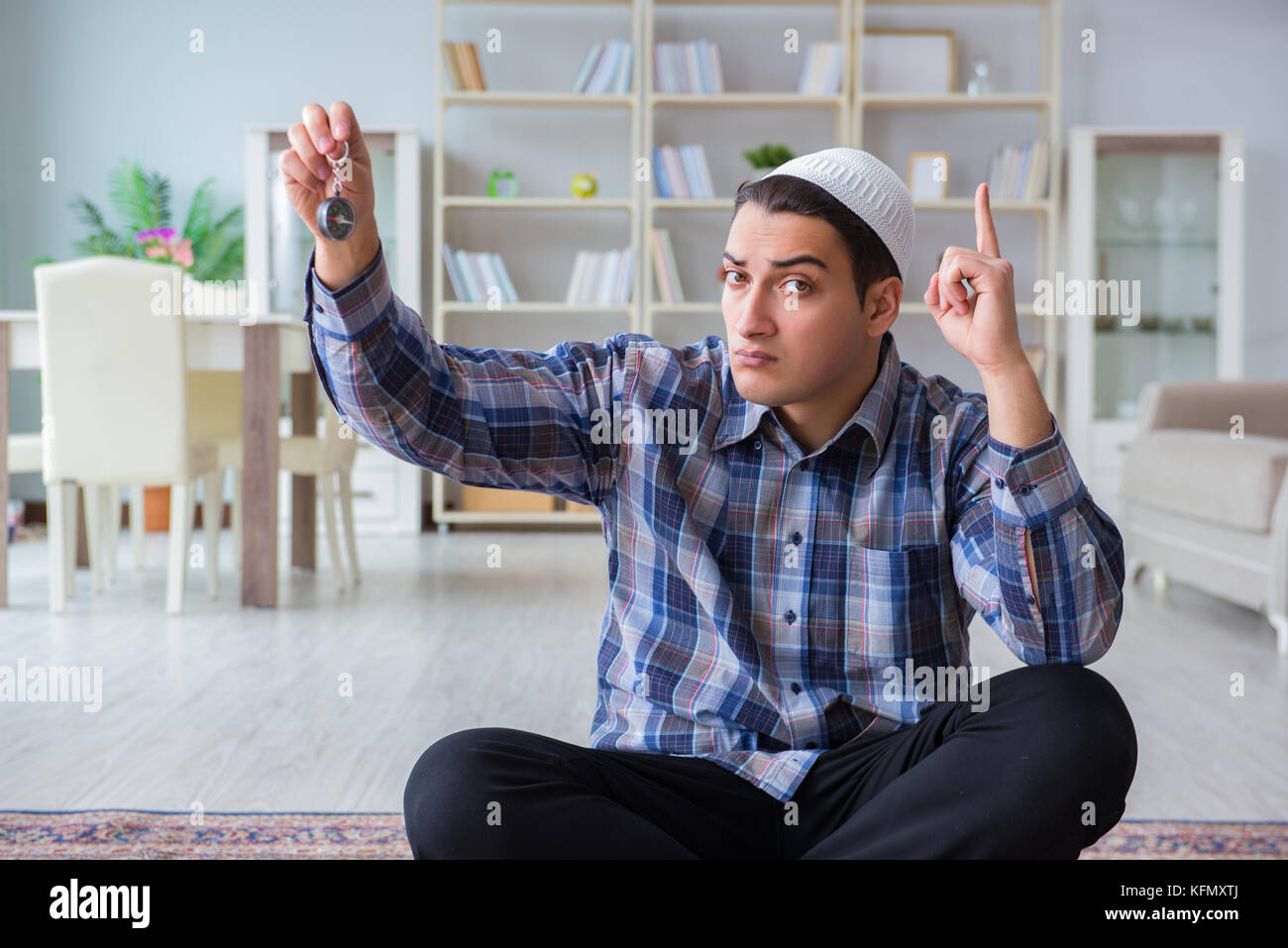 Young muslim man praying at home Stock Photo - Alamy