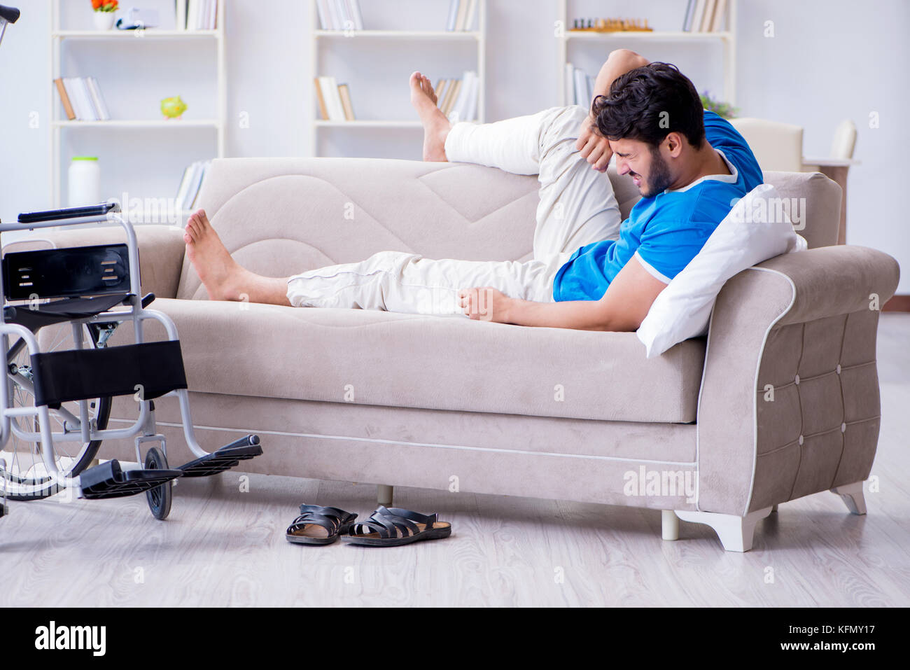 Injured young man recovering at home Stock Photo - Alamy