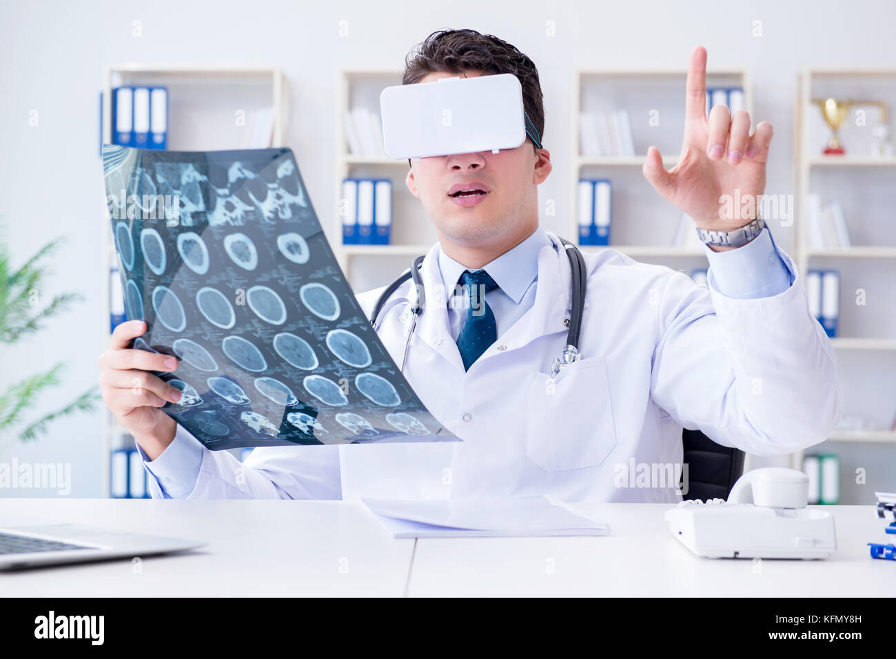 Young doctor looking at MRI scan through VR glasses Stock Photo - Alamy