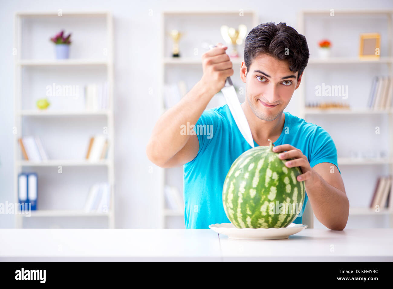 Man eating watermelon at home Stock Photo - Alamy