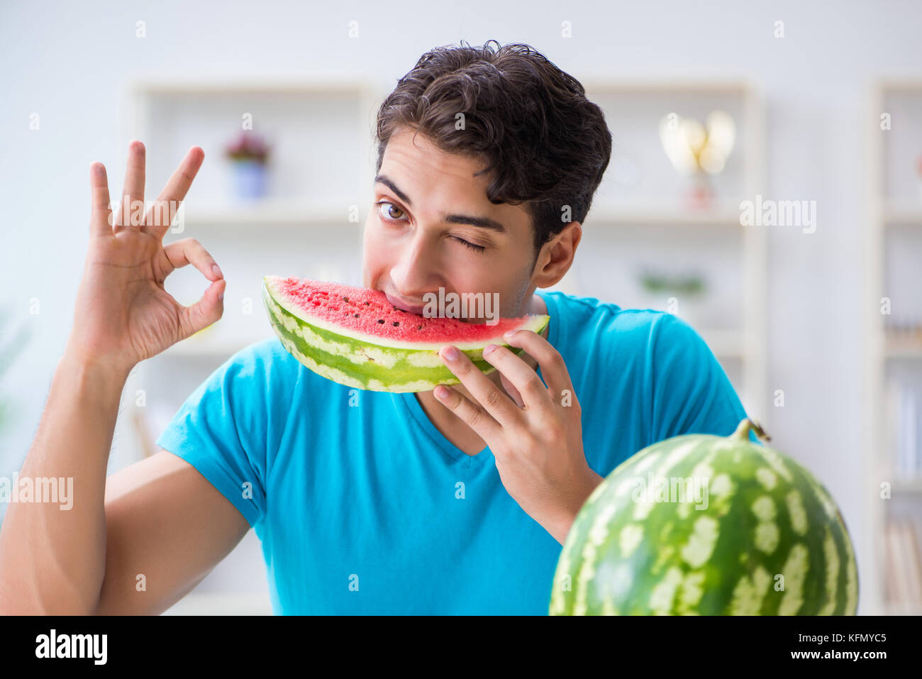 Man eating watermelon at home Stock Photo - Alamy