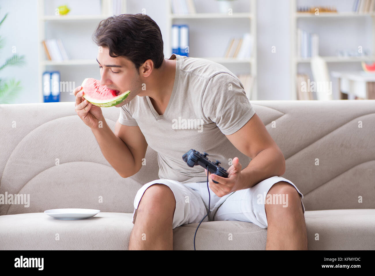 Man eating watermelon at home Stock Photo - Alamy