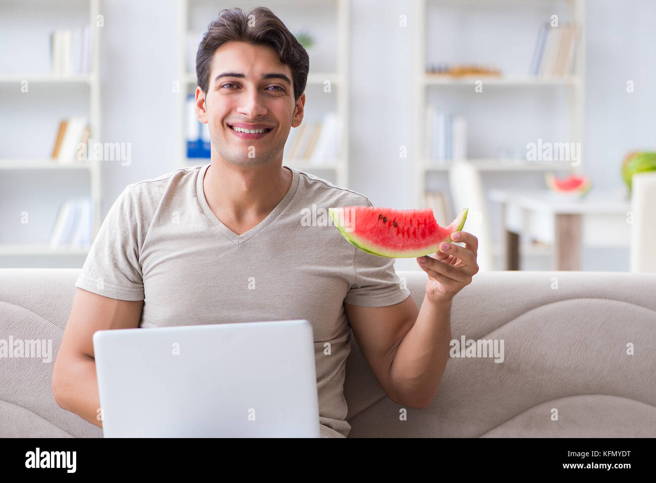 Man eating watermelon at home Stock Photo - Alamy