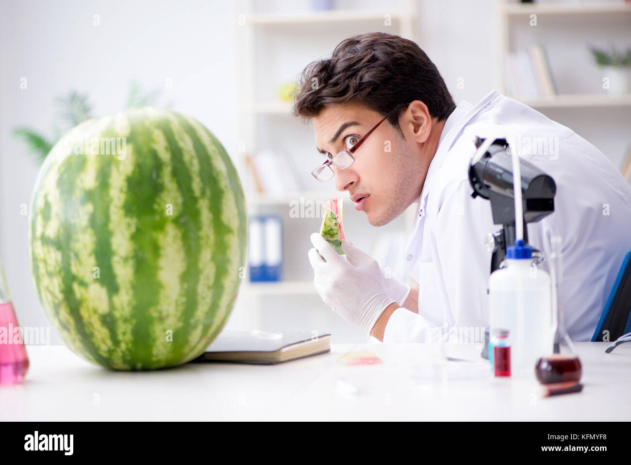 Scientist testing watermelon in lab Stock Photo - Alamy